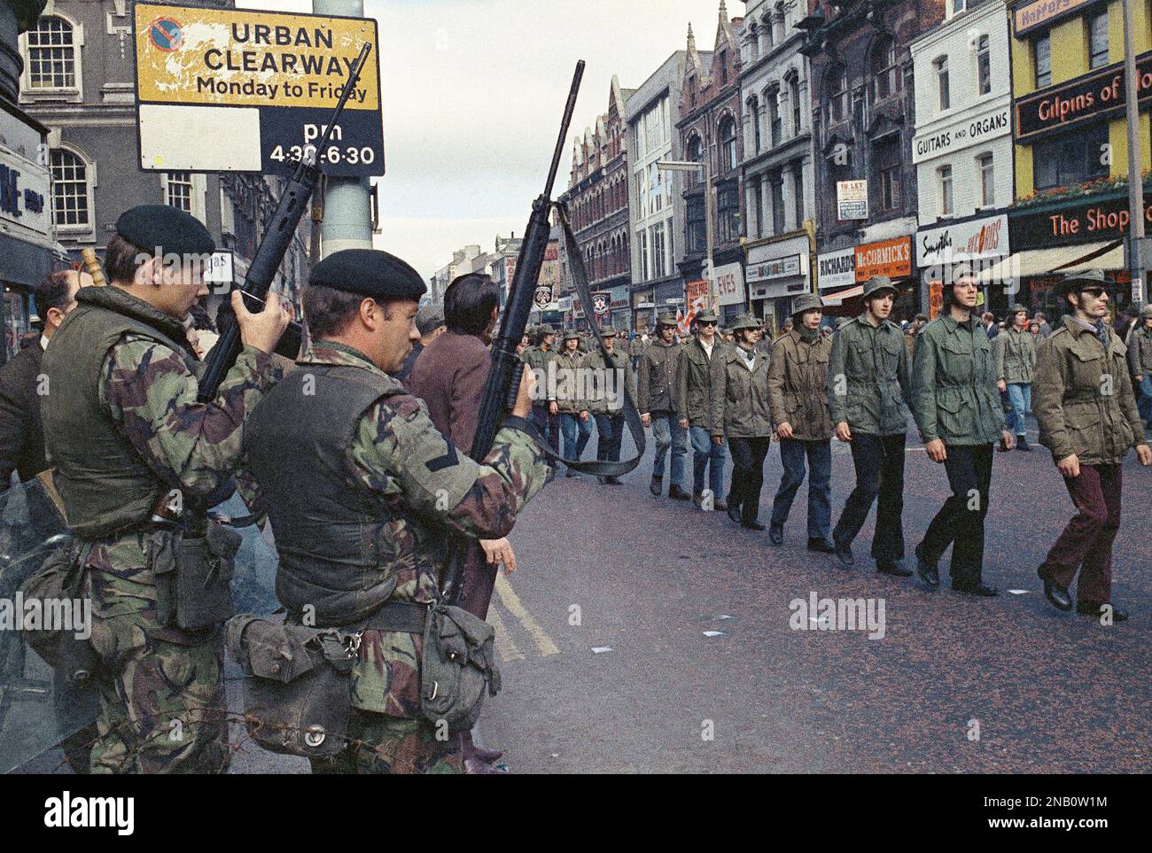 Under the watchful eyes of armed British troops, members of the Ulster ...