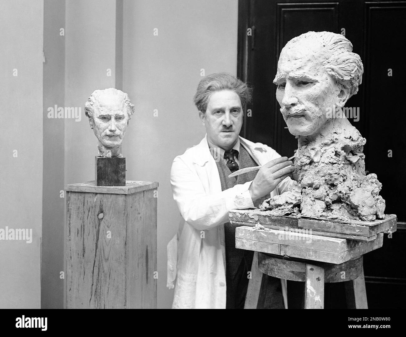 German-born British sculptor Benno Elkan with his bust of Arturo ...