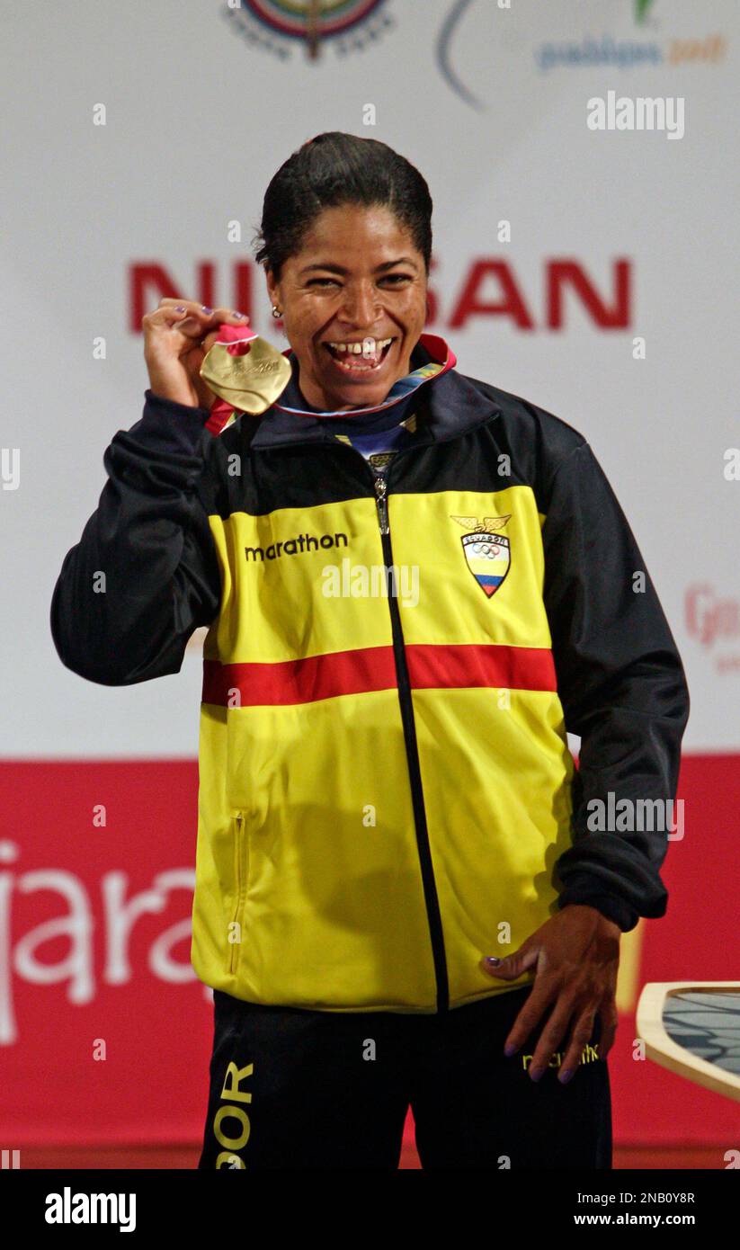 Maria Escobar, from Ecuador, holds her gold medal for the women's 58 kg ...