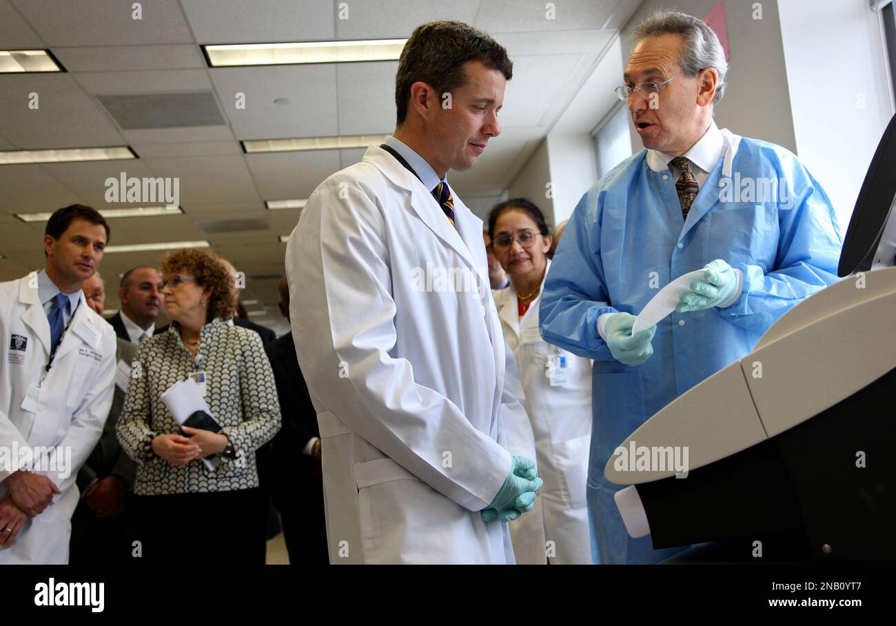 Crown Prince Frederik of Denmark, center, listens to Dr. Alan Beber ...