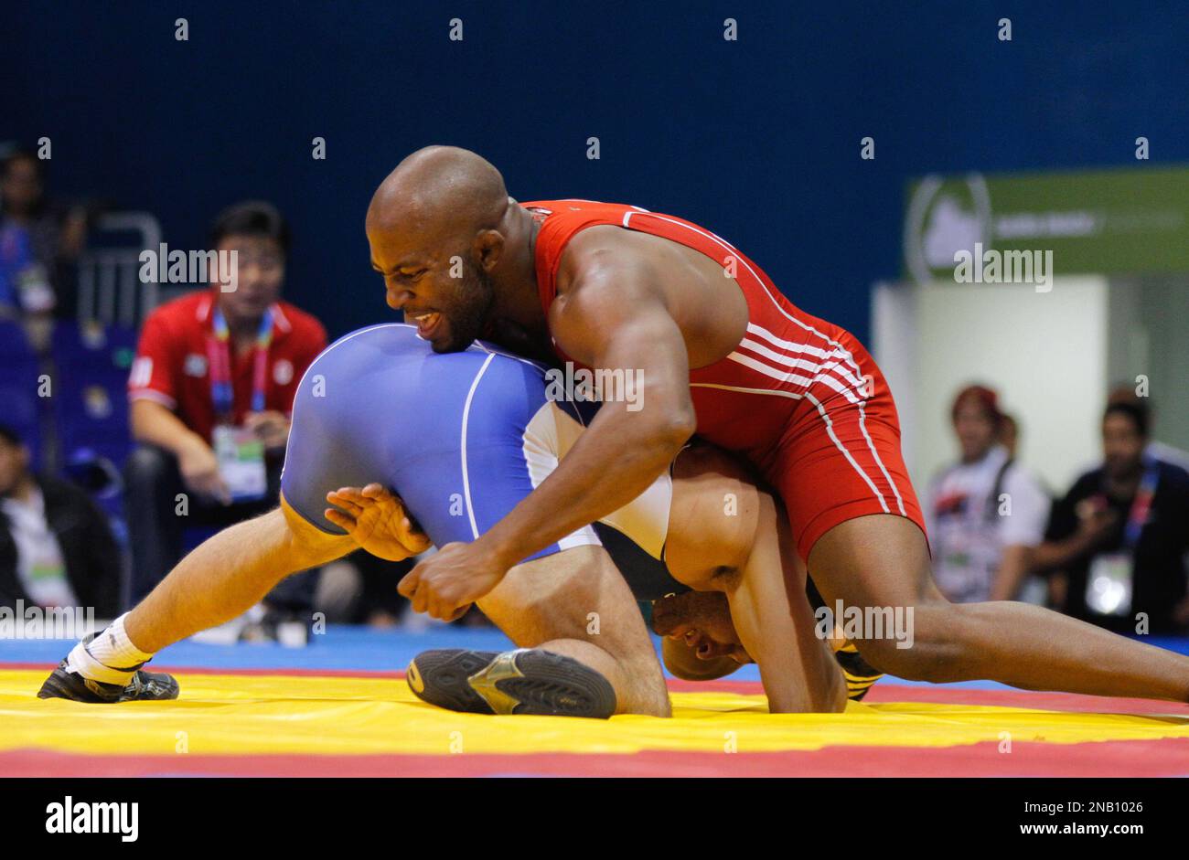 Cuba's Michel Batista, in red, wrestles with Canada's Khetag Pliev ...