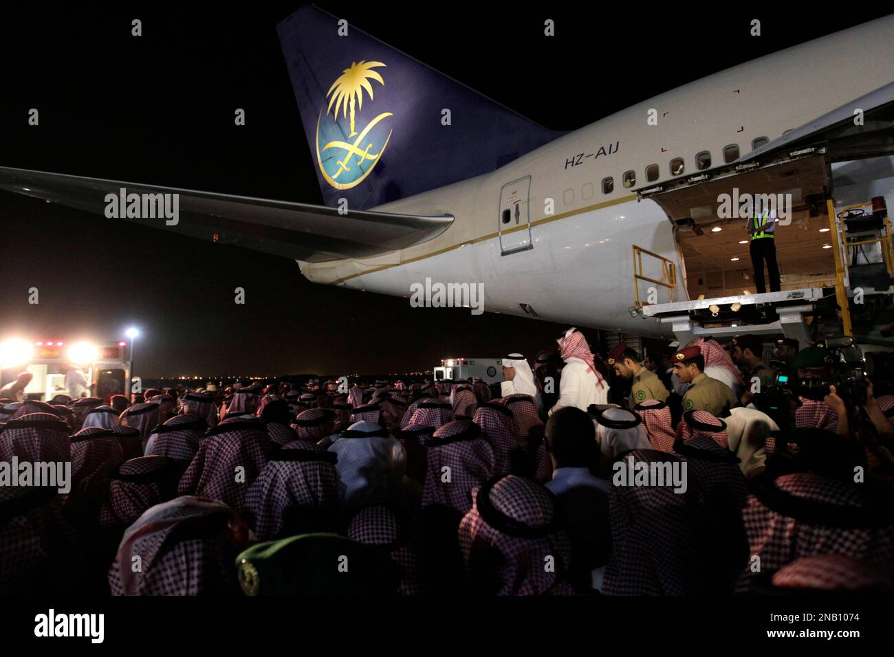 Relatives from the Saudi royal family lift the coffin of the late Saudi ...