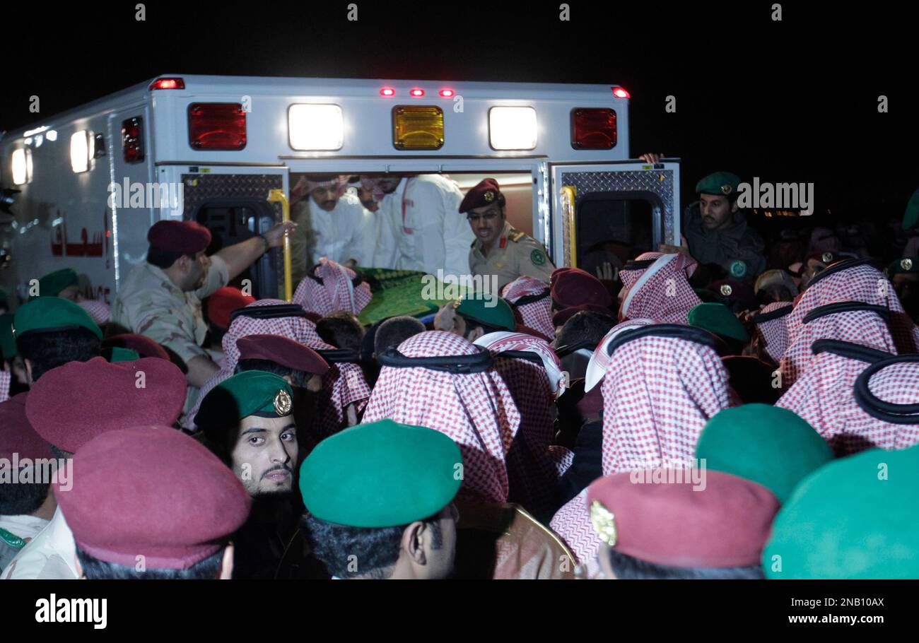 Relatives from the Saudi royal family lift the coffin of the late Saudi ...