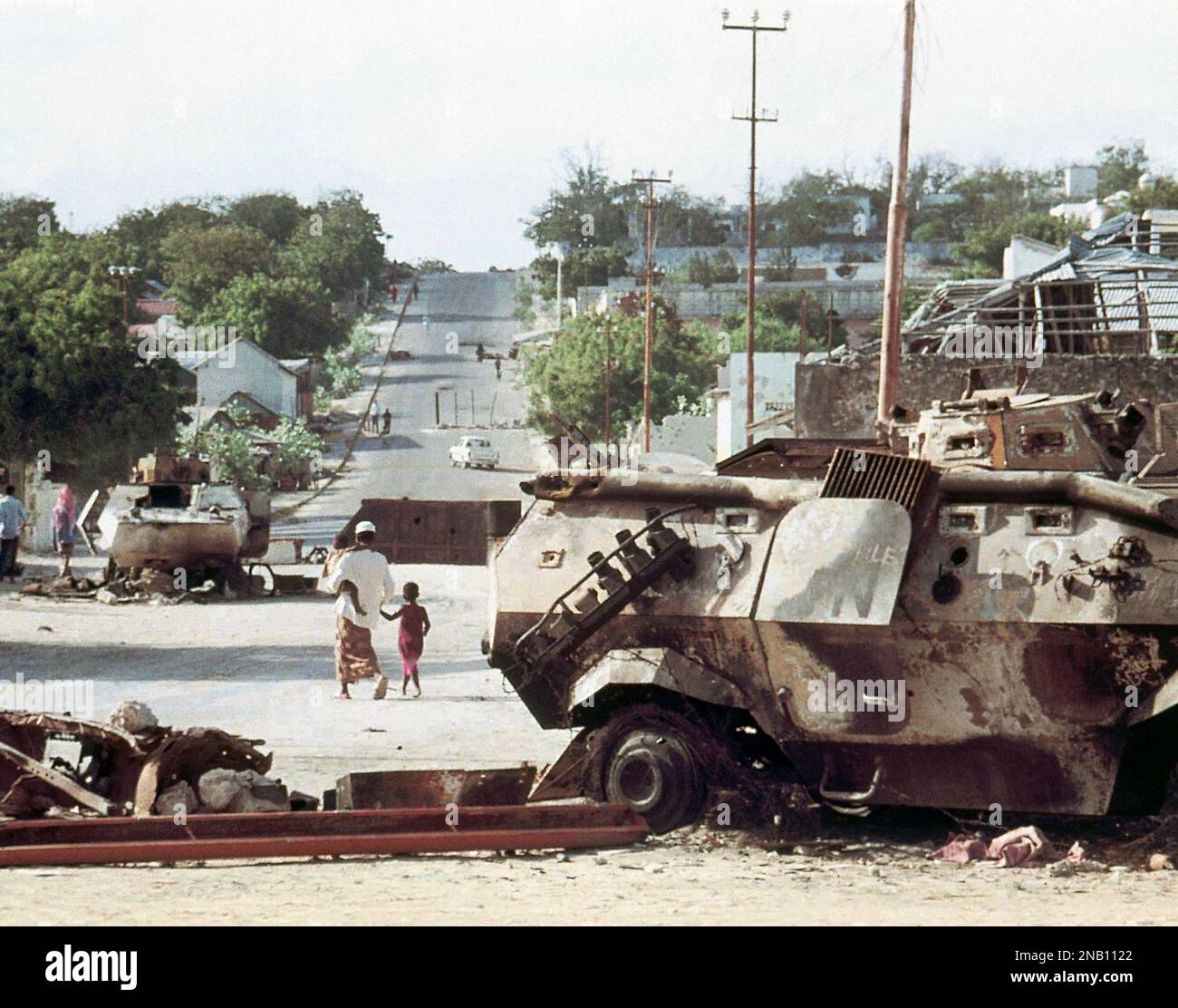 The burned out hulks of two Malaysian armored personal carriers sit ...