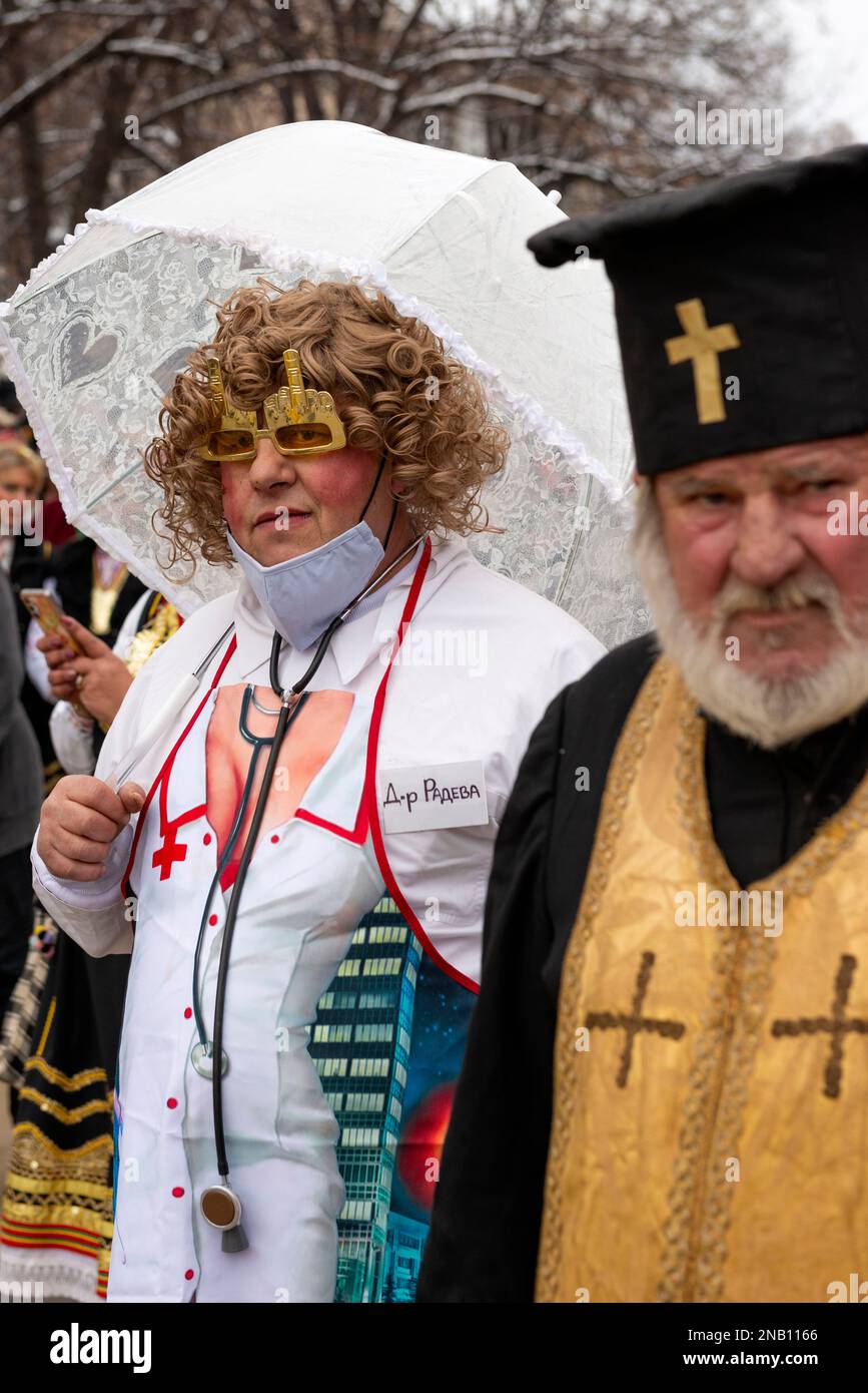 Men dressed in female nurse with funny glasses and priest costumes at ...