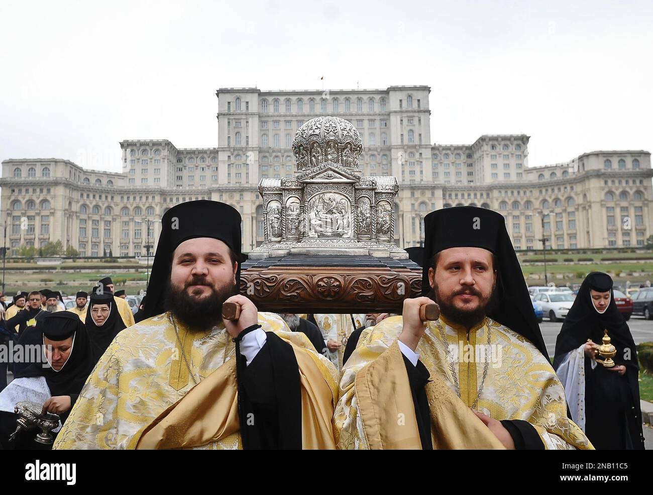 Romanian orthodox priests carry in Bucharest, Romania, Monday, Oct. 24 ...
