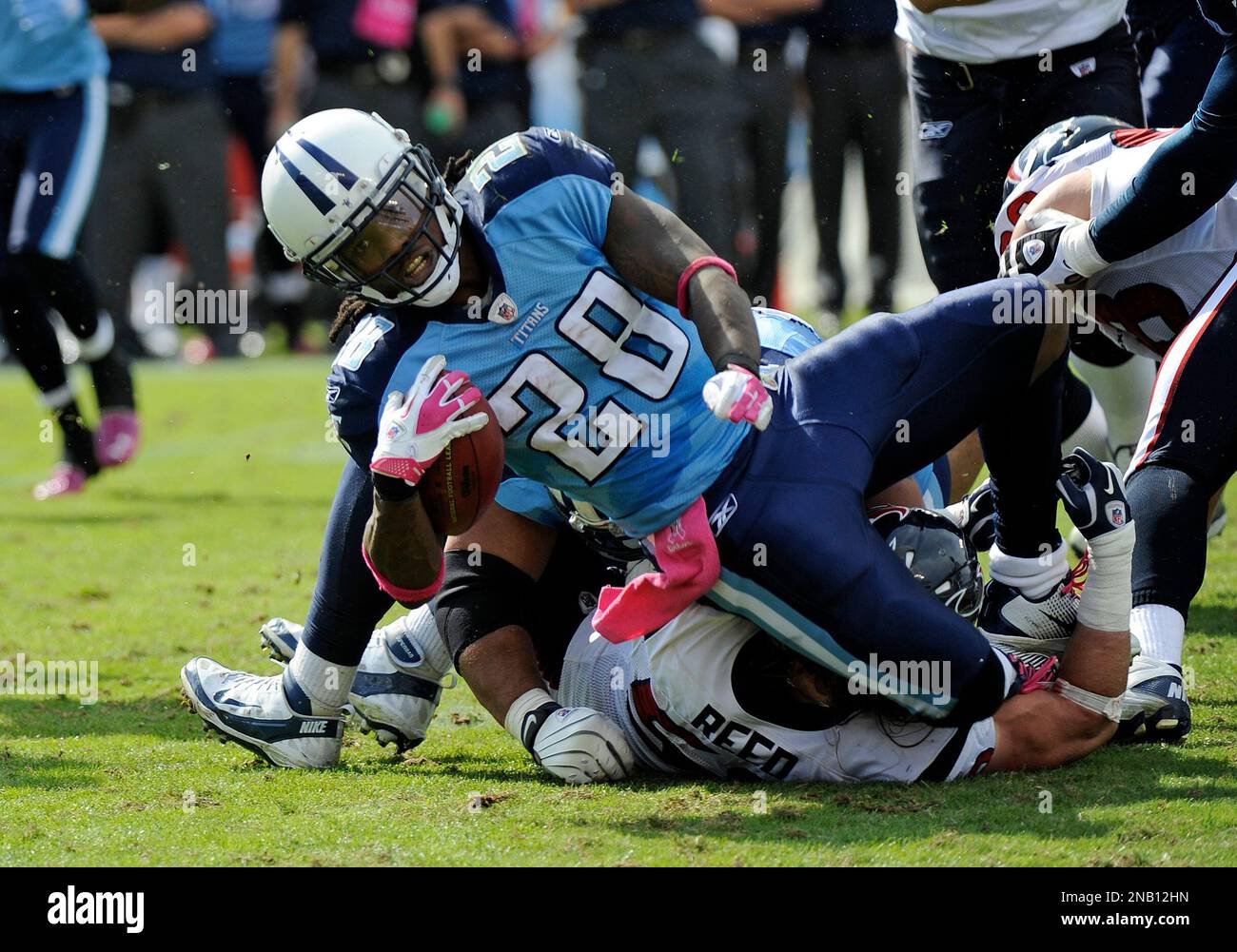 Tennessee Titans running back Chris Johnson (28) is brought down while ...