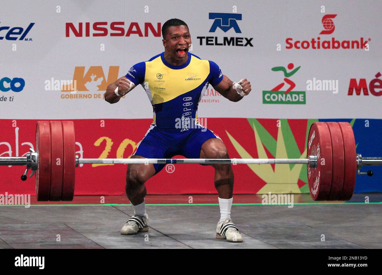 Gold medal winner Colombia's Oscar Figueroa celebrates after lifting ...