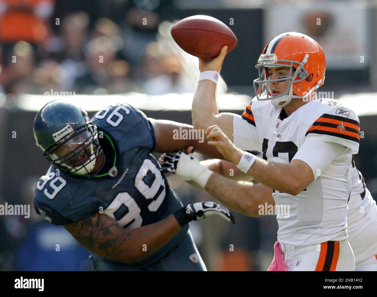 Cleveland Browns quarterback Colt McCoy, right, throws under pressure ...