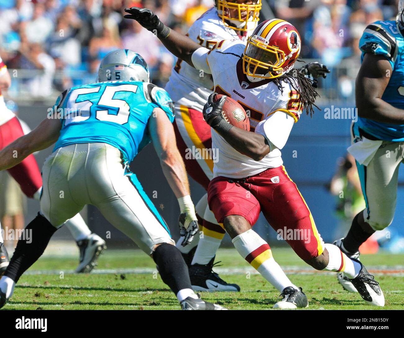 Washington Redskins' Tim Hightower, right, turns to avoid Carolina ...