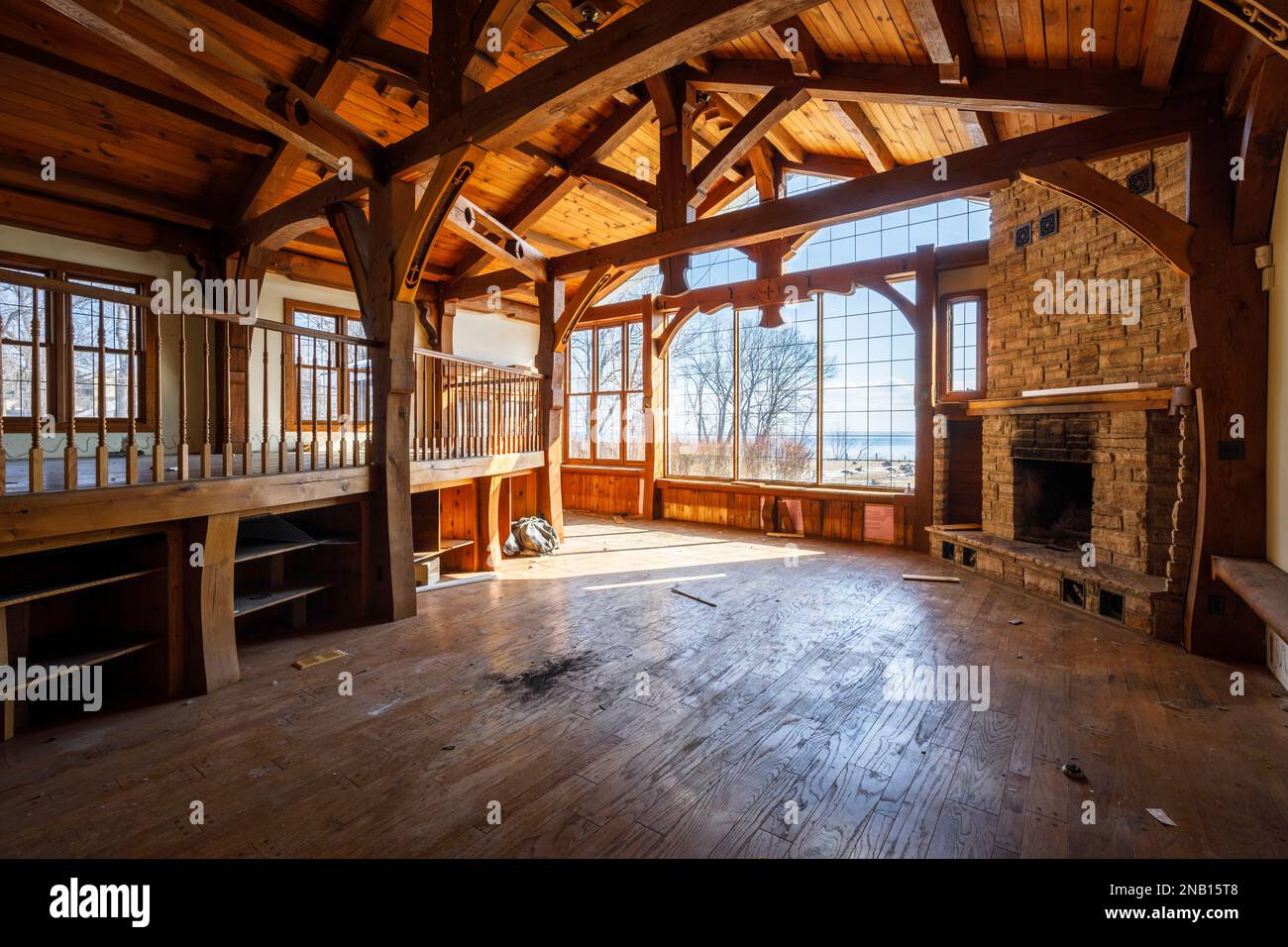 A large wooden and rustic living room inside an abandoned house. This ...
