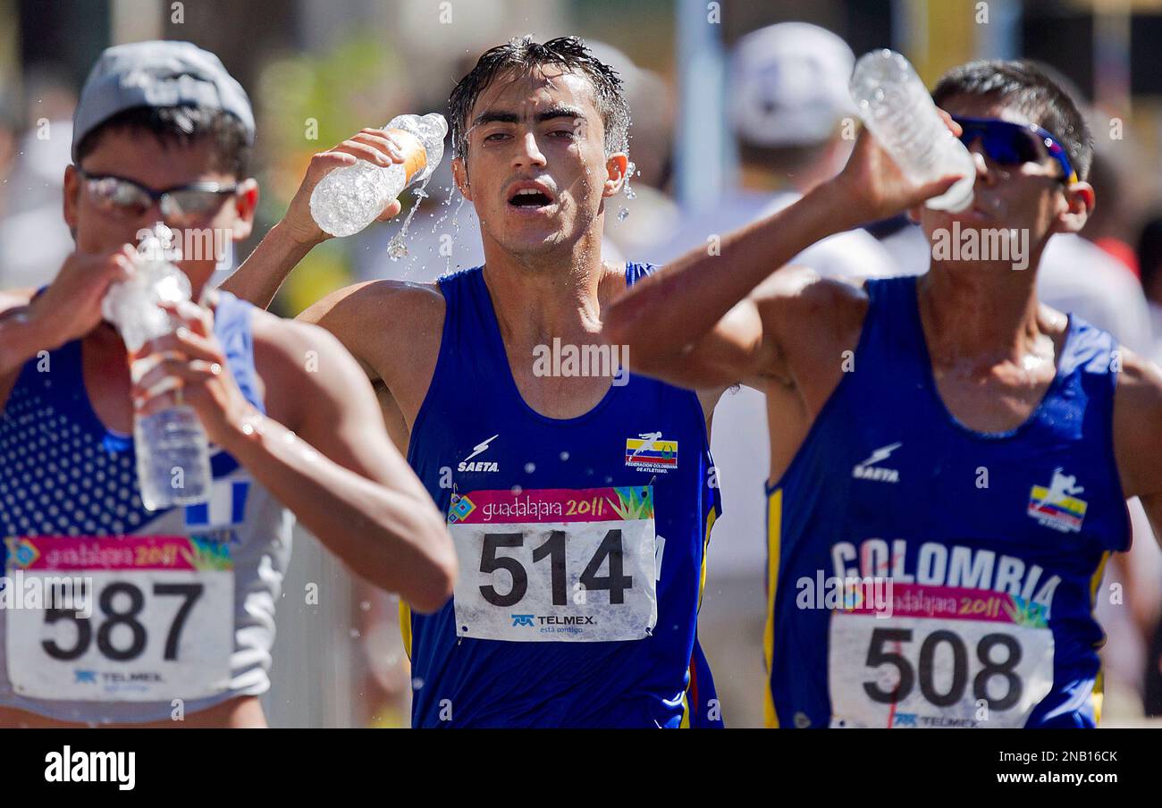 Colombia's James Rendon, center, douses himself with water as he ...