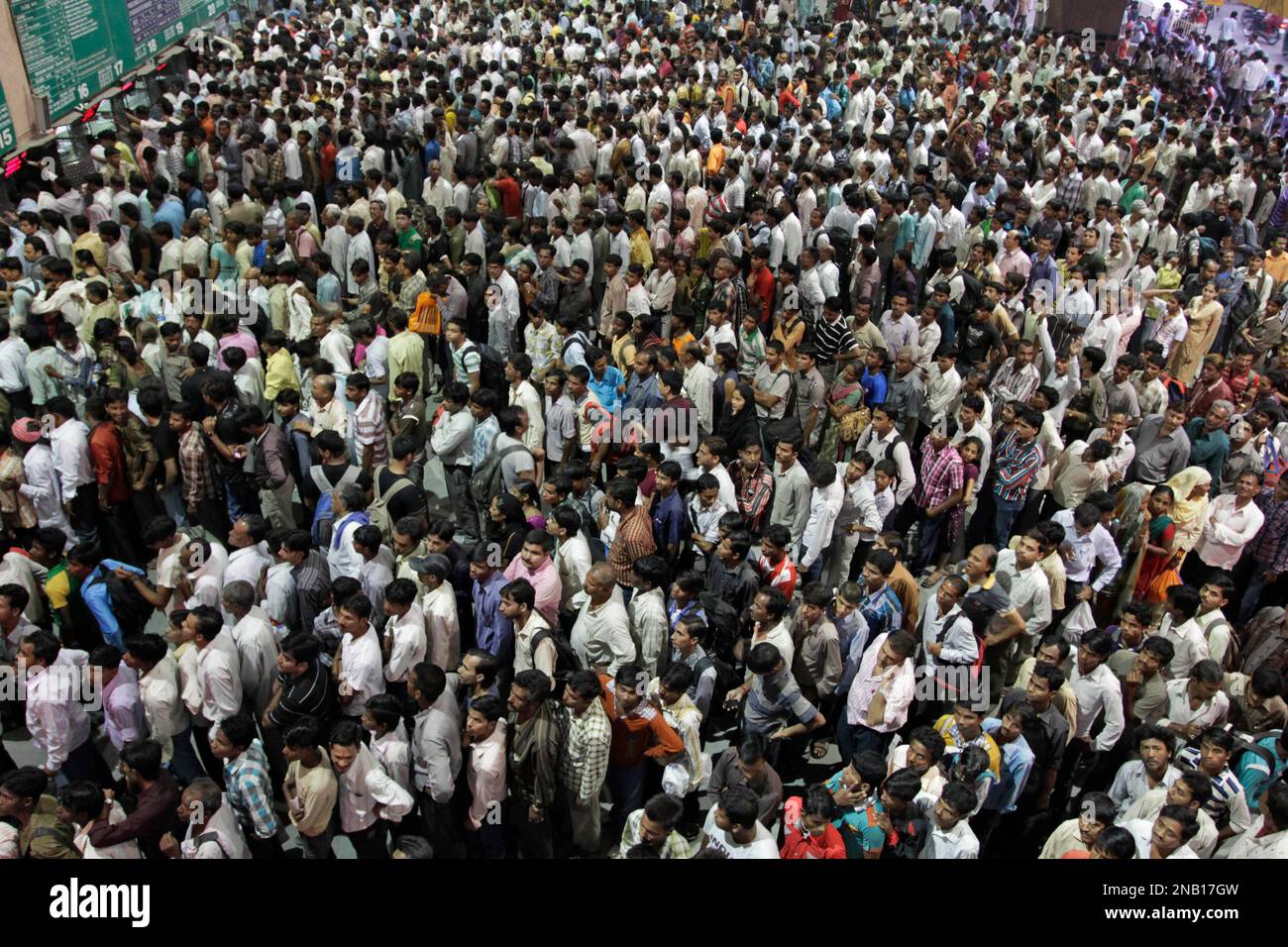 Indians crowd ticket counters at the railway station in Ahmadabad ...