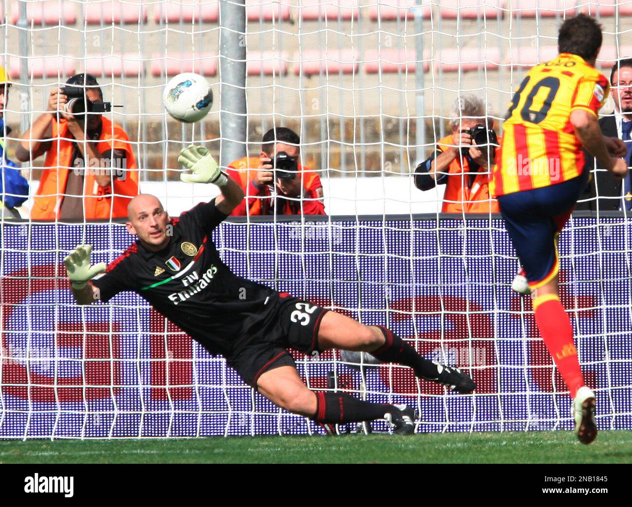 Lecce's Massimo Oddo, right, scores from a penalty kick against AC ...