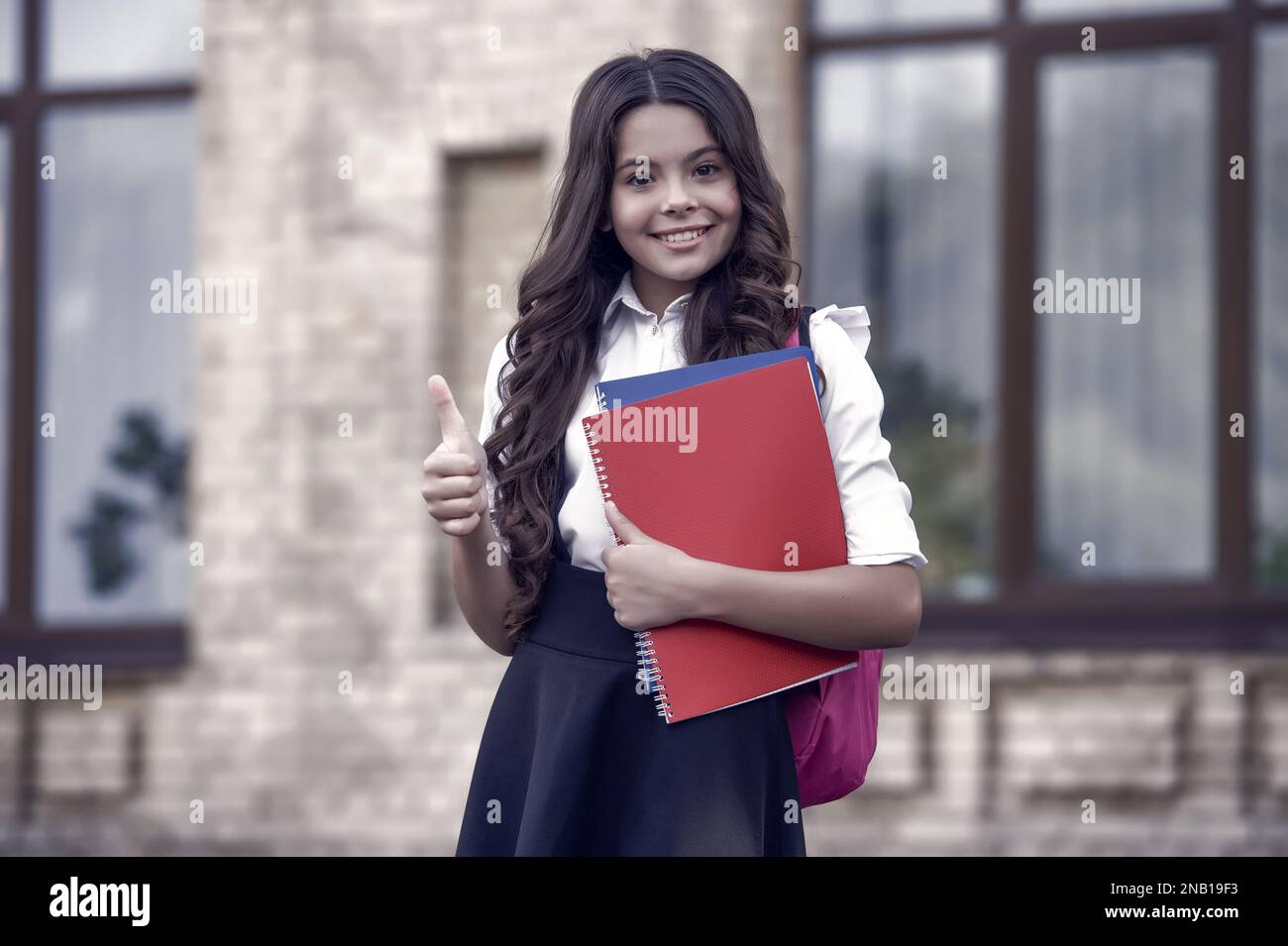 Happy small kid in back to school style give thumbs up hand gesture ...