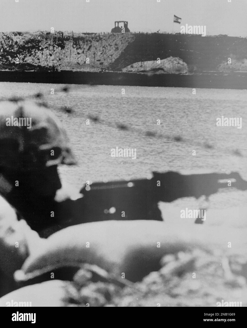 An Egyptian soldier, foreground with gun, keeps watch on Israeli ...