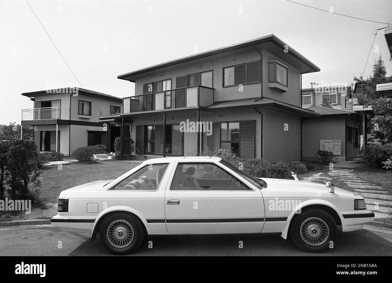 A Toyota car is parked in front of Toyota houses in Toyota City, an ...