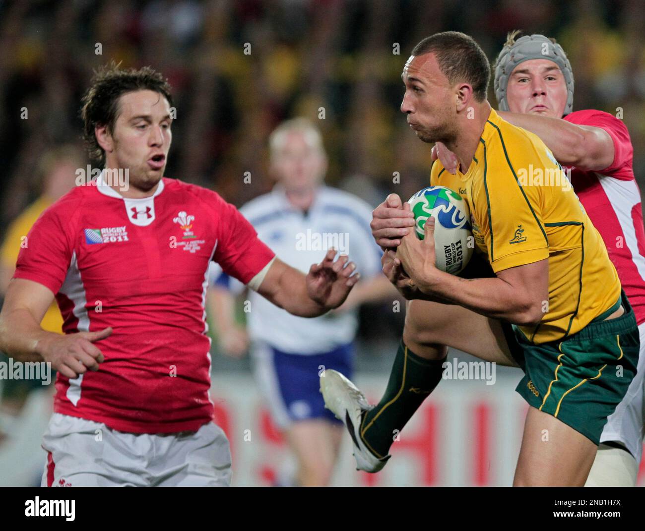 Australia's Quade Cooper is tackled by Wales' Jonathan Davies, right ...
