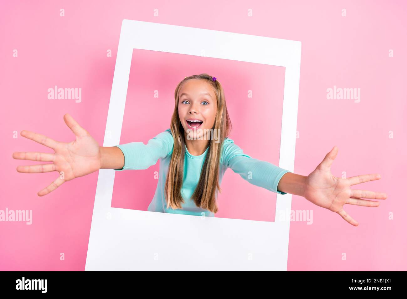 Photo of crazy cheerful person raise arms through paper album card ...