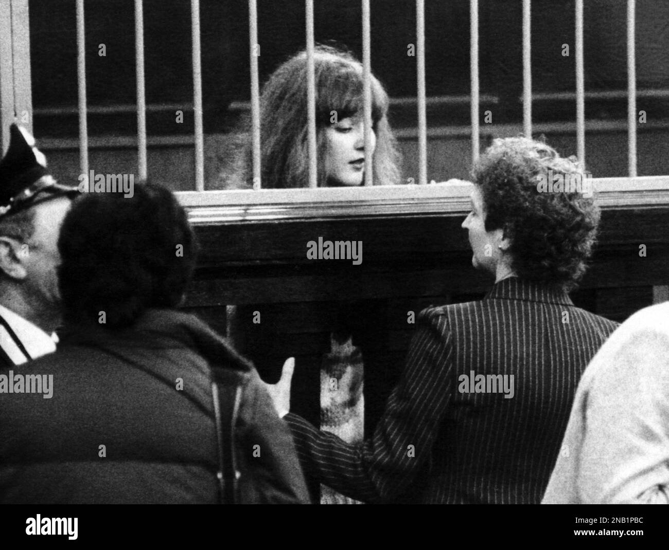 Carol Compton, a 21 - year - old Scottish nanny, talks to her mother Pamela from behind the bars ...