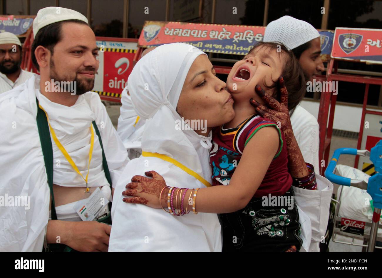 An Indian Muslim pilgrim, center, consoles her daughter in Ahmadabad ...