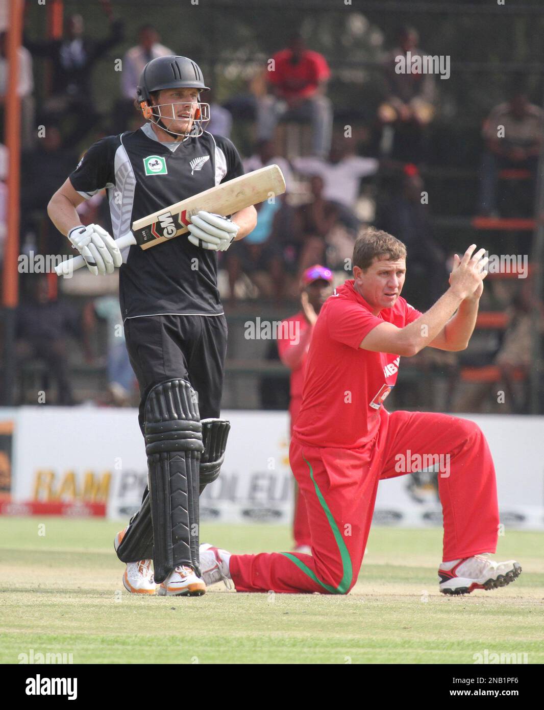New Zealand batsman Rob Nicol completes his run while Zimbabwean bowler ...