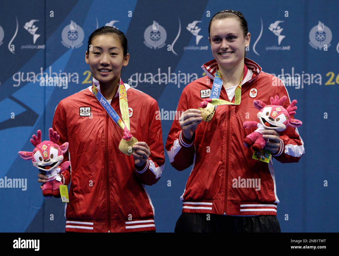 Canada's players Li Michelle, left, and Alex Bruce hold their gold ...
