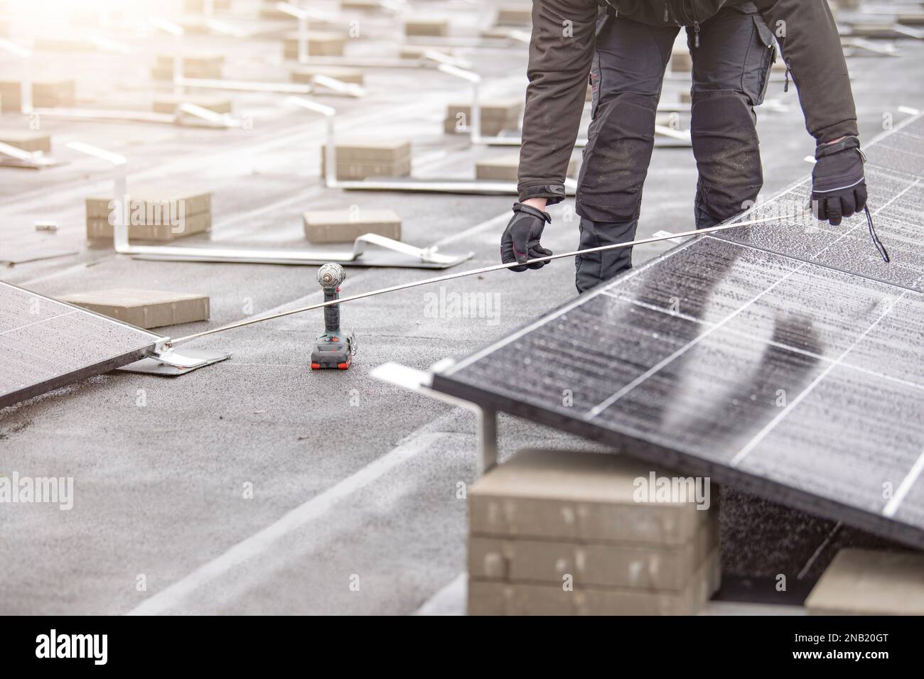 The process of installing solar panels. The installer measures the ...