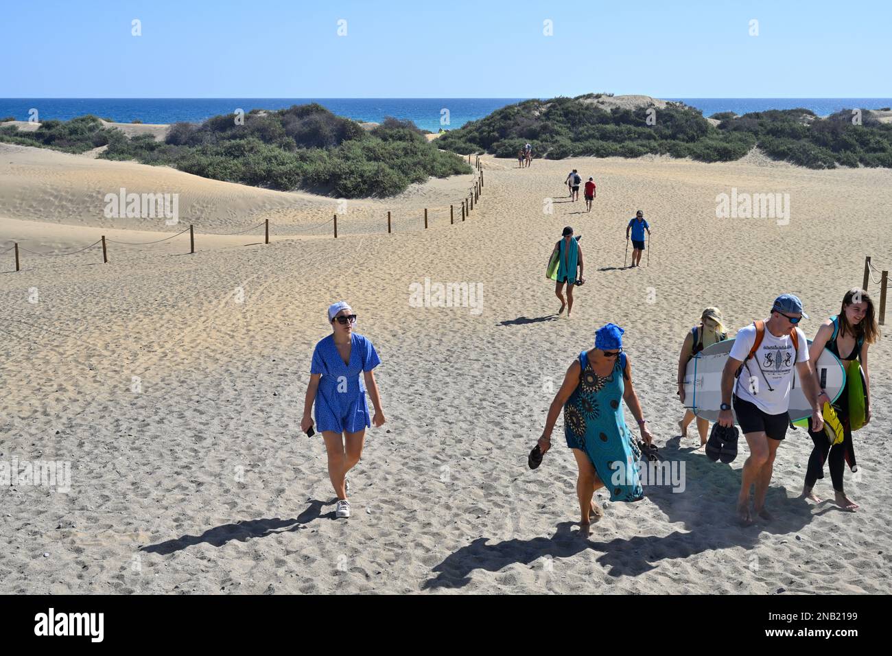 People walking across Maspalomas Sand Dunes, Canary Islands Stock Photo ...