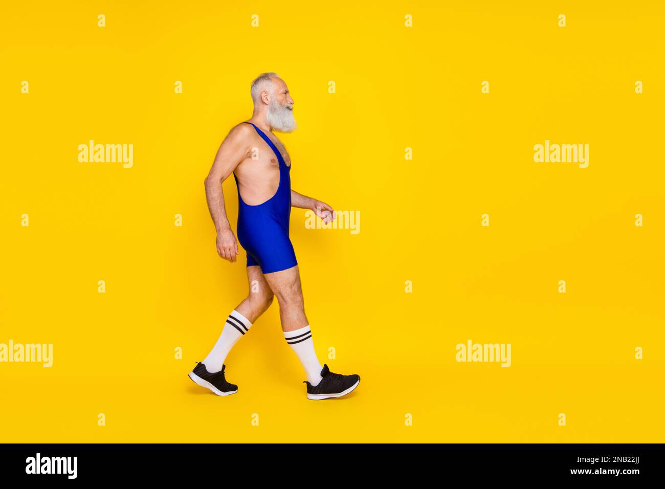 Full length profile photo of sportive aged man walking look empty space ...