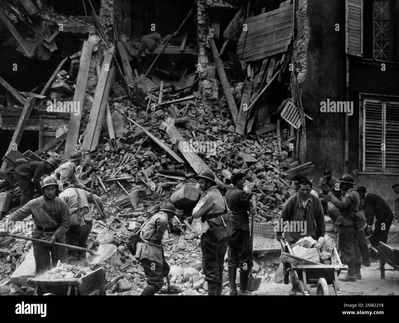 French soldiers clear debris from house damaged by bombs in German air ...