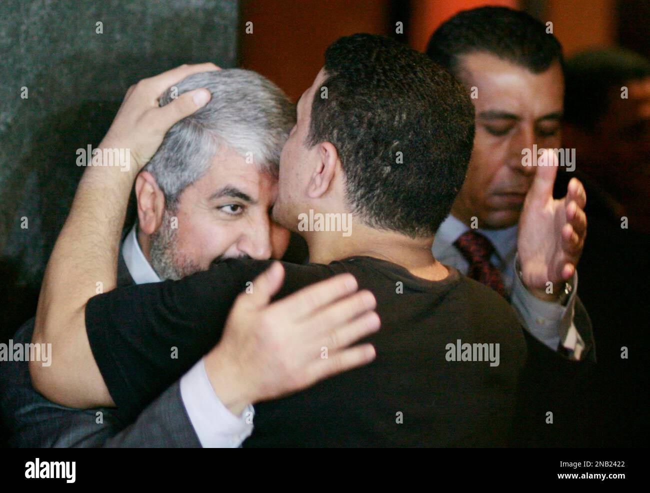 Hamas political leader Khaled Meshal, left, greets a released ...