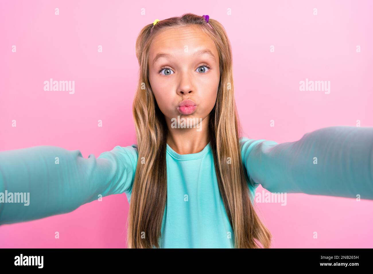 Closeup photo of young small cute schoolgirl kid pouted lips kiss hold ...