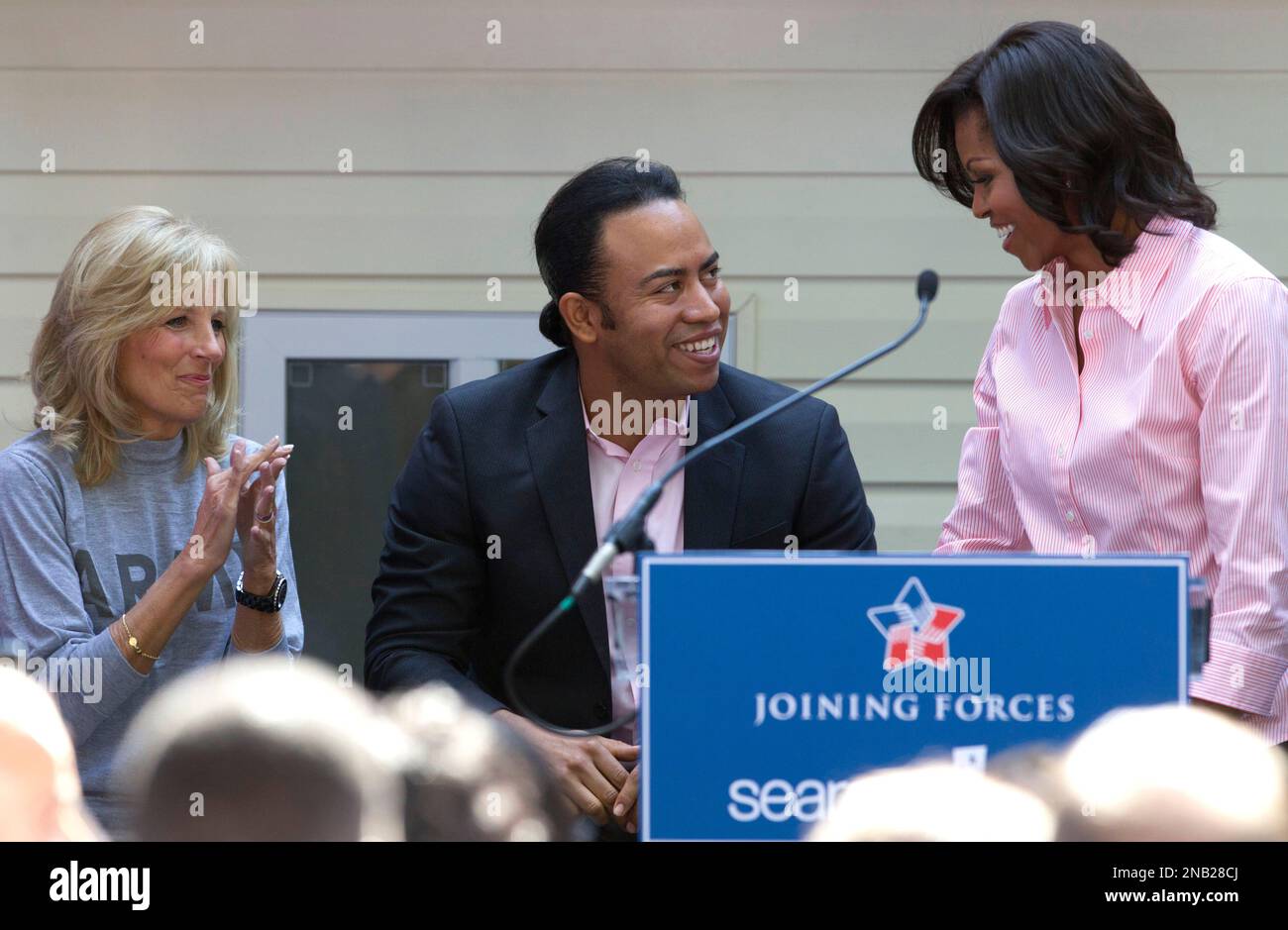 First lady Michelle Obama greets Army Sgt. Johnny Agbi, center, with ...