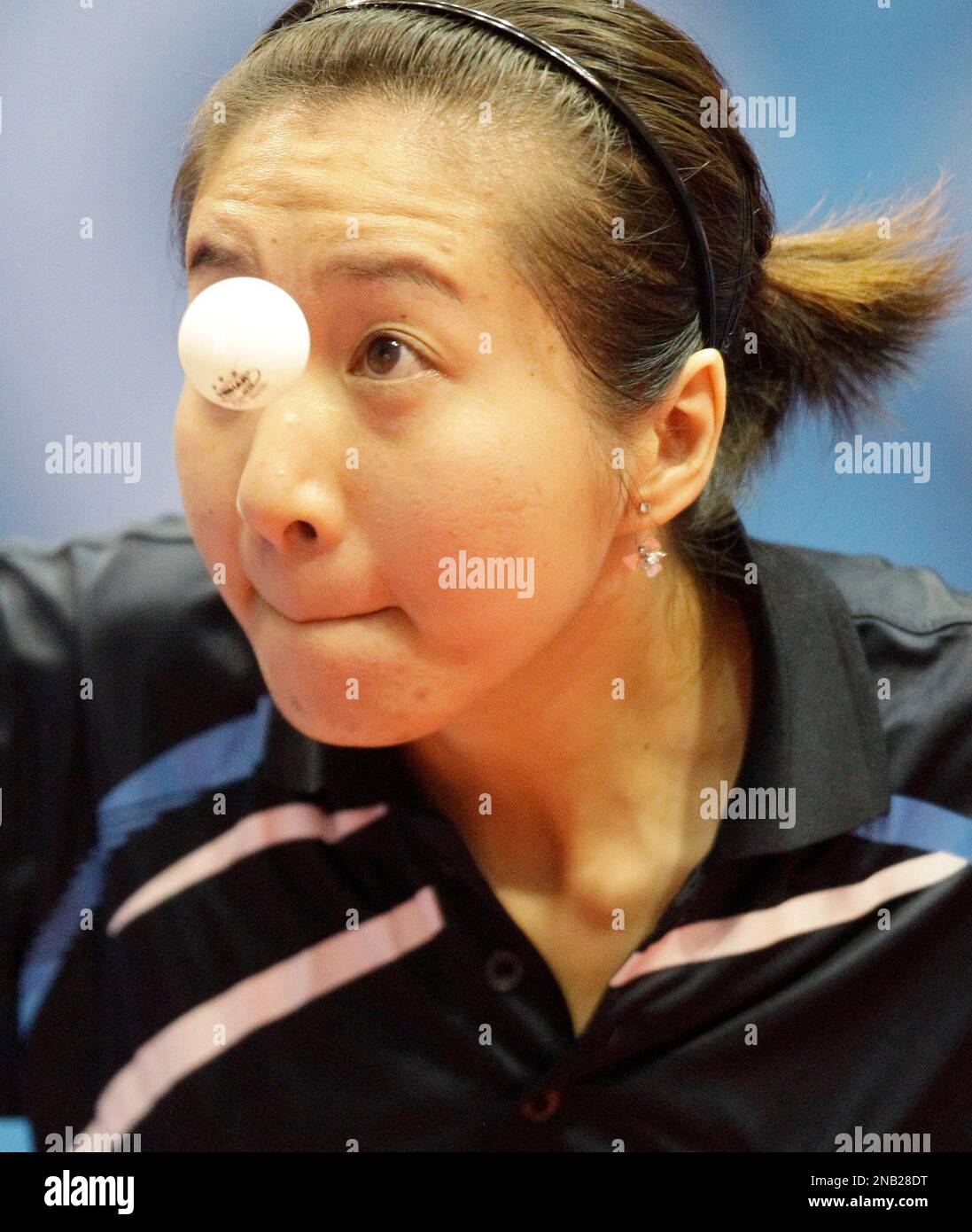 Dominican Republic's Wu Xue eyes the ball as she returns it to ...