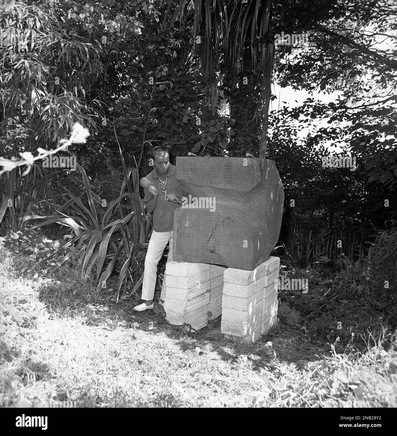 Thirty-two-year-old British painter and sculptor John Milne chips away ...