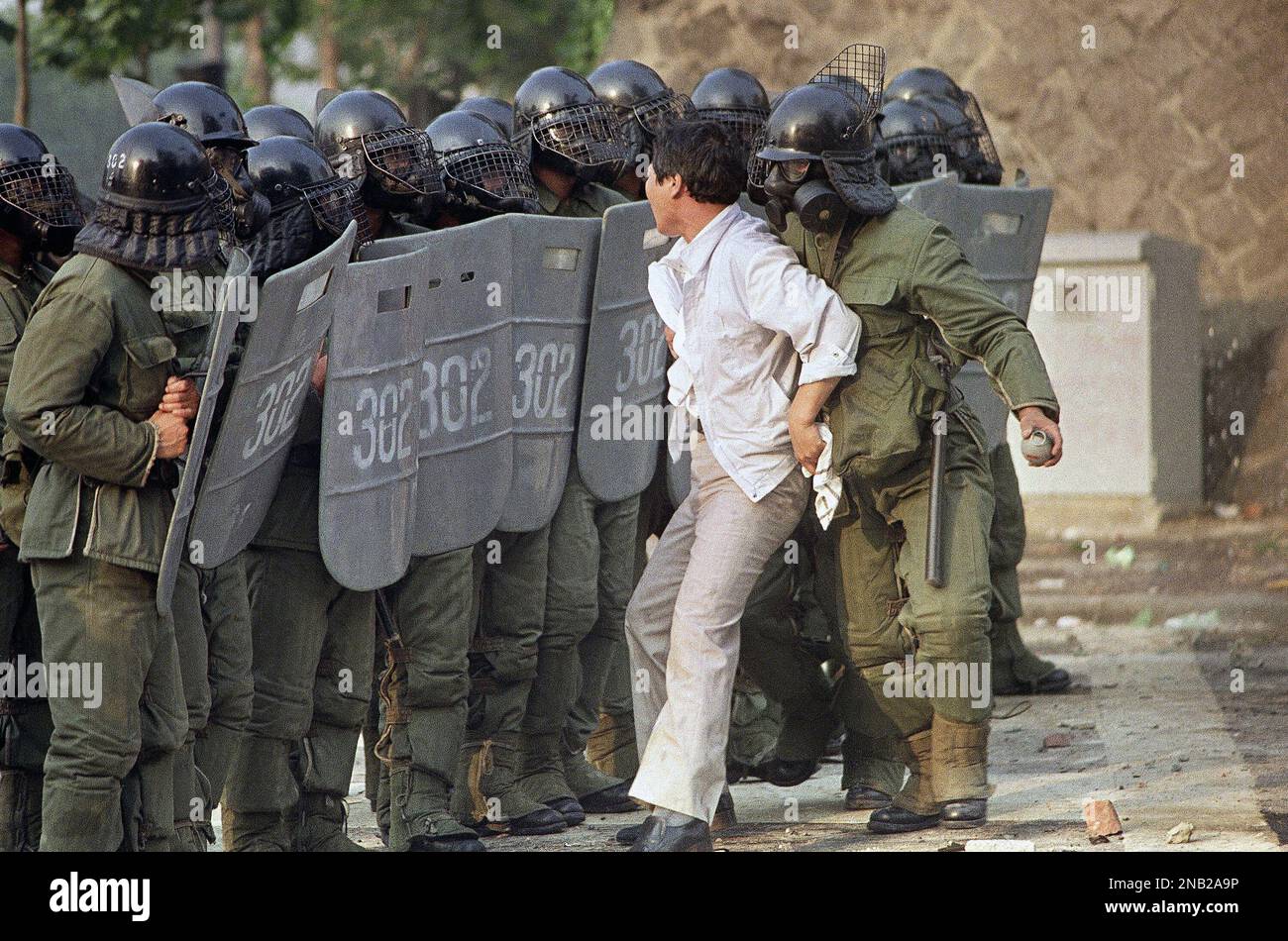 Riot police stand hold up shields during an anti government protest by ...