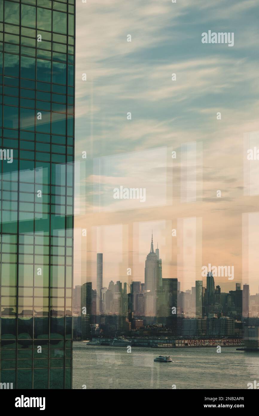 A vertical daytime view of the NYC skyline behind a window Stock Photo ...