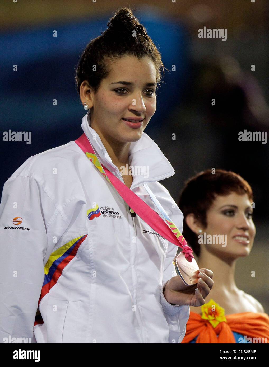 Venezuela's Andreina Pinto, left, holds the bronze medal as she poses ...