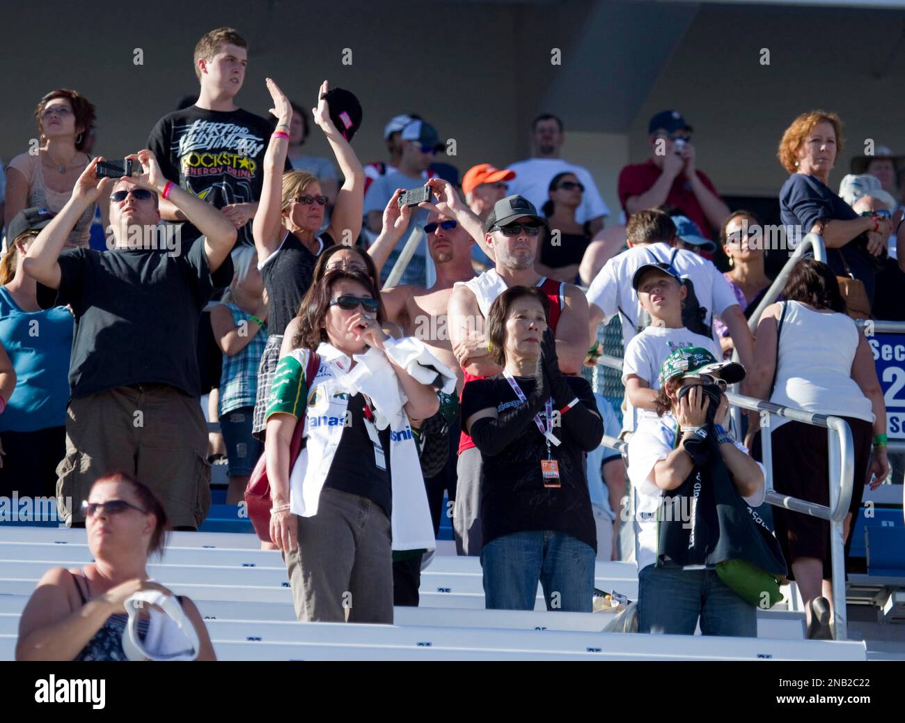 Fans stand as drivers take five tribute laps in honor of Dan Wheldon, a ...