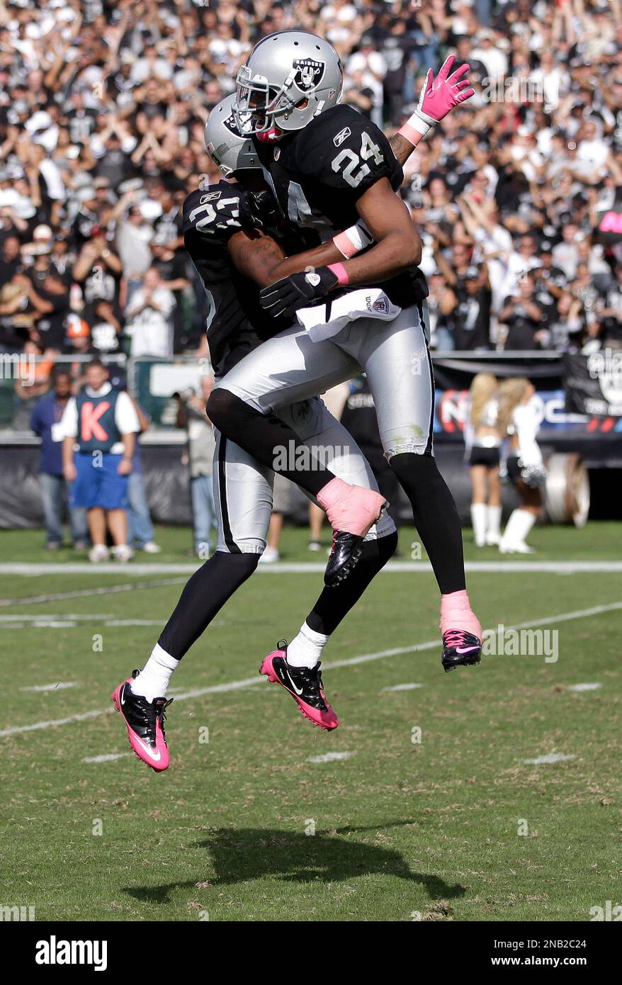 Oakland Raiders cornerback DeMarcus Van Dyke (23) and safety Michael ...