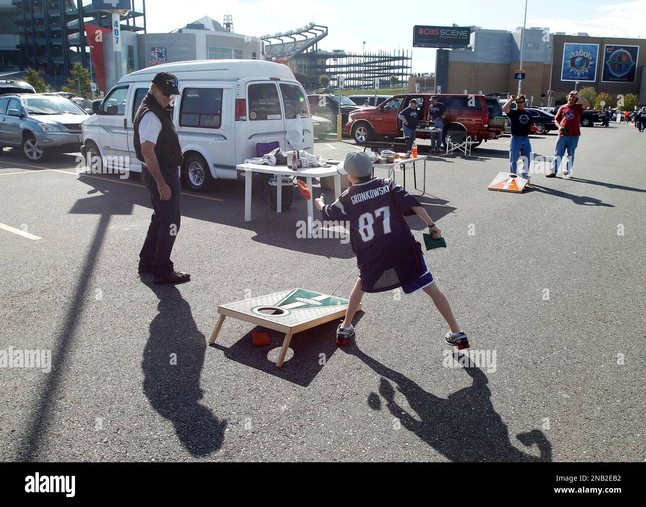 New England Patriots fans play bean bag toss while tailgating prior to ...