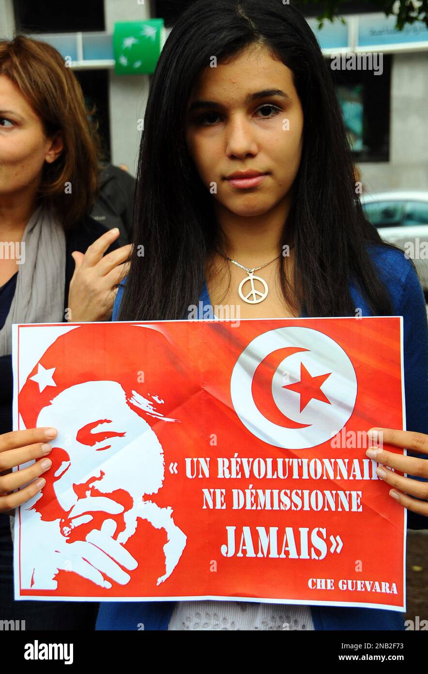 A demonstrator holds a poster of Che Guevara reading "A revolution man ...