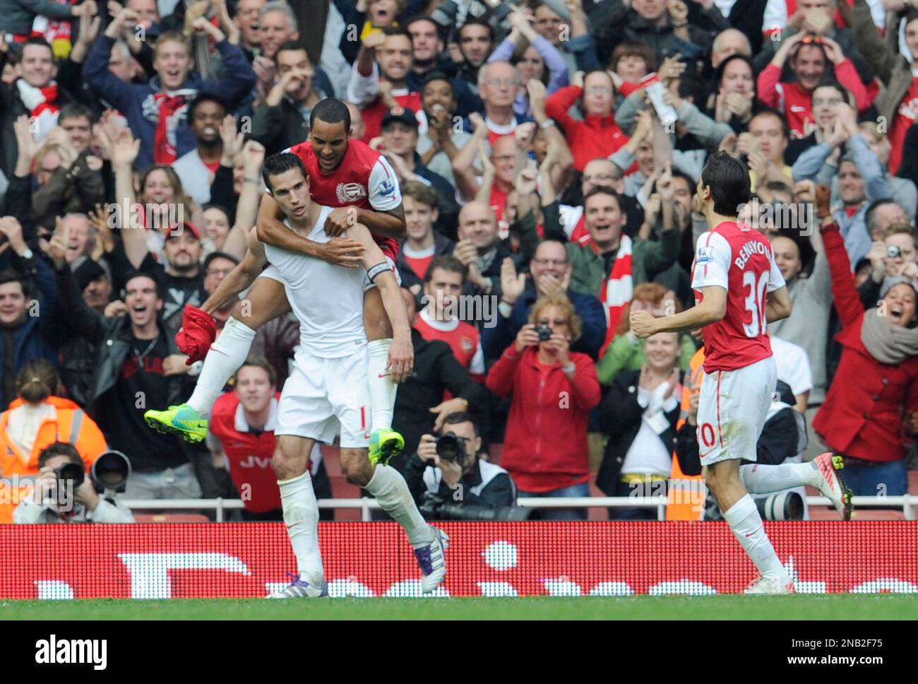 Arsenal's Robin van Persie, left, carries teammate Theo Walcott, 2nd ...