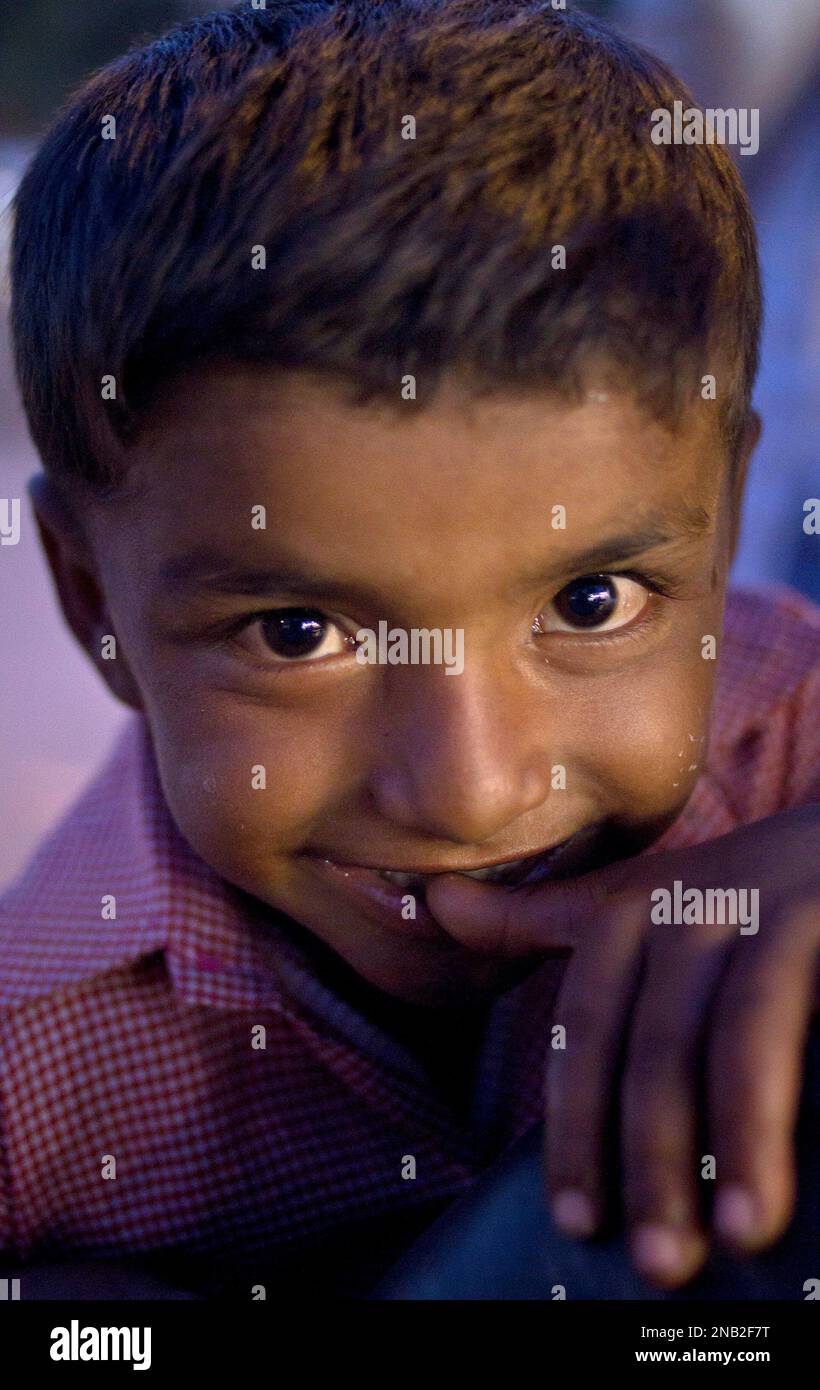 A Pakistani boy waits to receive free food from a food distribution ...