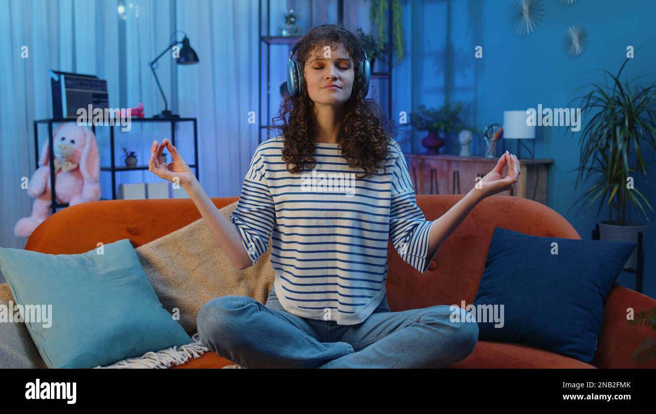 Keep calm down, relax. Woman with curly hairstyle at home couch ...