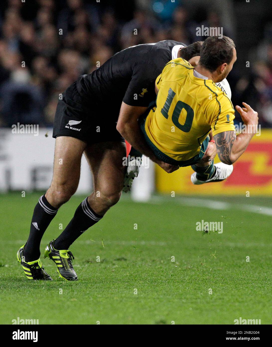 New Zealand All Blacks Richard Kahui tackles Australia's Quade Cooper ...