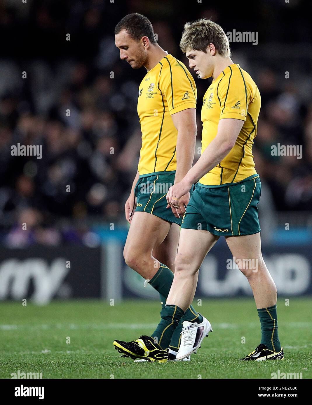Australia's Quade Cooper and James O'Connor, right, leave the field ...