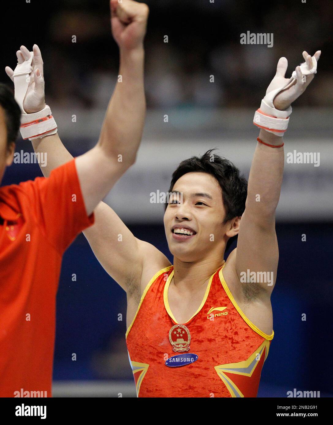 Zou Kai of China reacts after his performance, on his way to winning ...