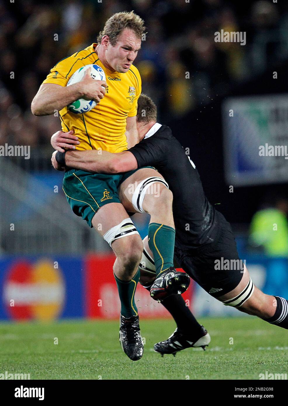 Australia's Rocky Elsom is tackled by New Zealand All Blacks Brad Thorn ...